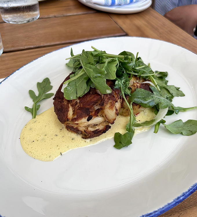 That golden-crusted crab cake topped with peppery arugula is exactly what dreams are made of, assuming you dream correctly. 