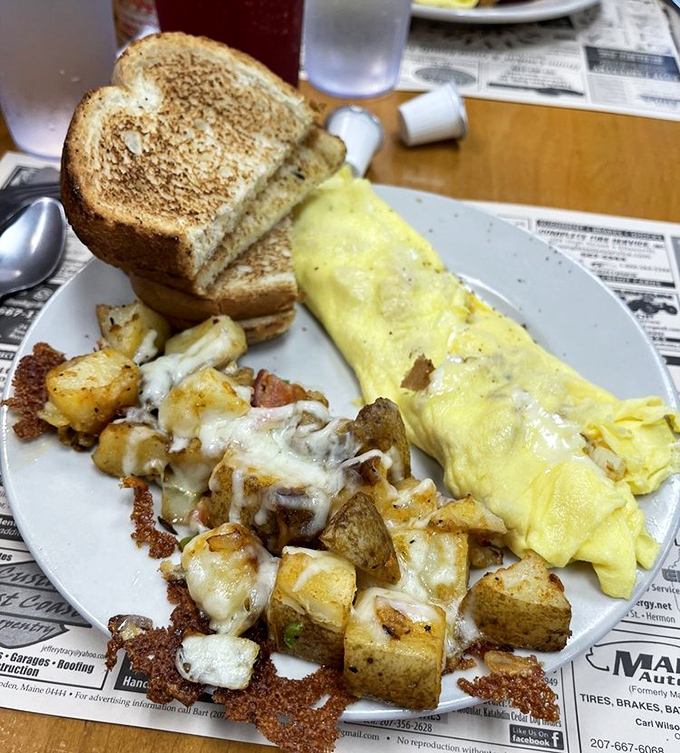 Behold the star attraction: a perfectly executed omelet alongside home fries that achieve the golden-brown perfection we all attempt but rarely achieve at home. This is breakfast nirvana.