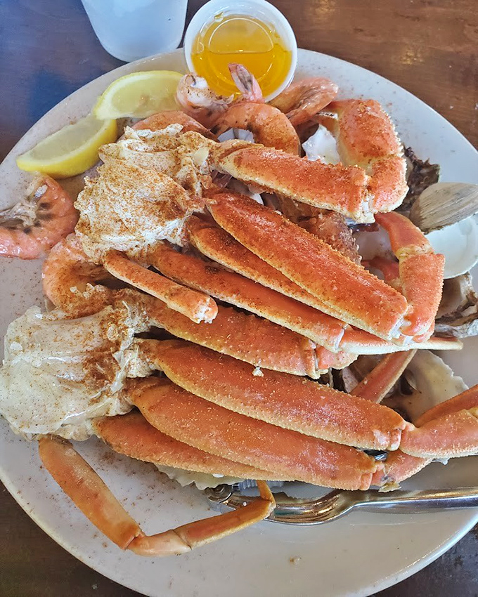 Snow crab legs arranged like nature's architecture—a delicious puzzle waiting to be solved. That little cup of melted butter? Your golden ticket to seafood nirvana.