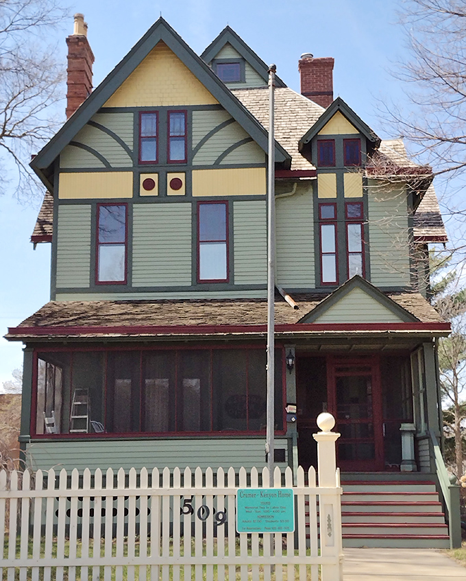 The Cramer-Kenyon Heritage Home stands as a Victorian masterpiece, its colorful facade and white picket fence embodying the American dream from a more graceful era.