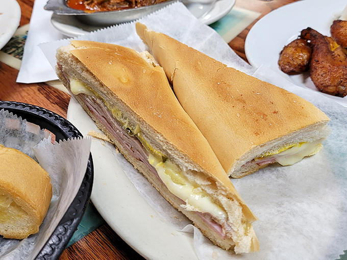 The Cuban sandwich in its natural habitat&mdash;pressed to perfection, layers visible like geological strata of deliciousness that archaeologists of flavor would study for centuries.