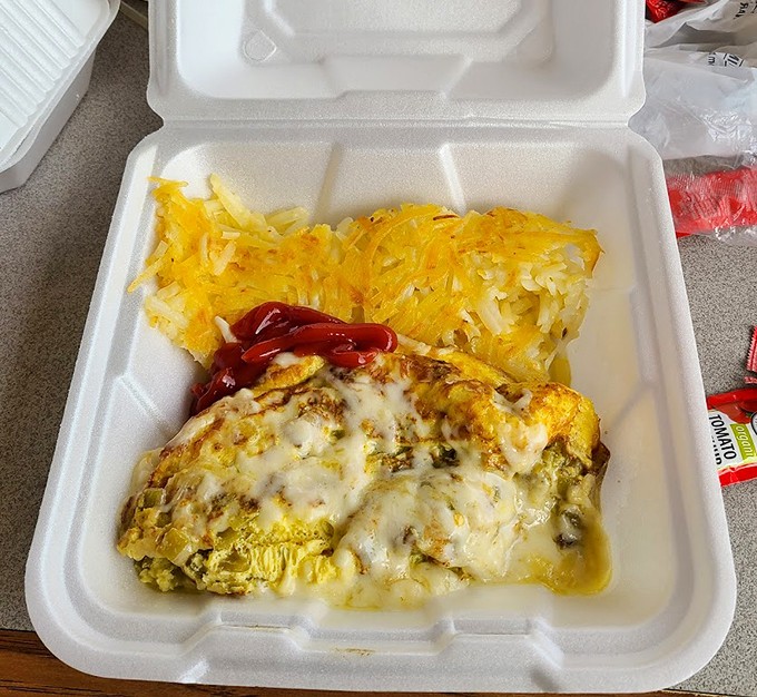 The legendary Denver omelet in its to-go glory&mdash;perfectly diced ham, peppers, and onions folded into fluffy eggs with hash browns that could make a potato farmer weep.