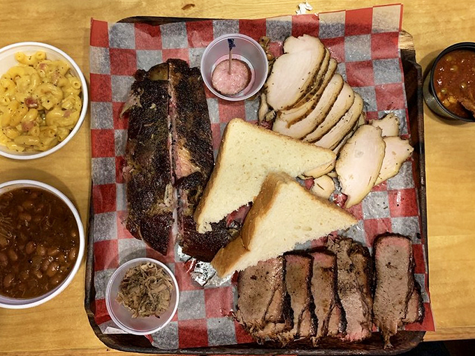 BBQ perfection doesn't need fancy plating. This sampler platter speaks a universal language that translates to "prepare for a nap afterward."