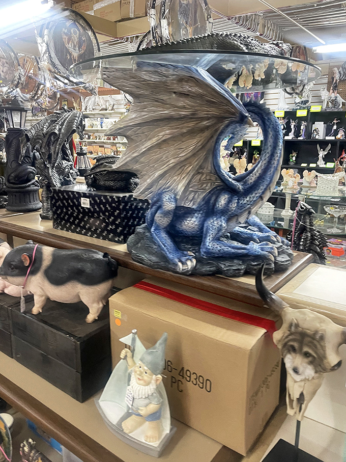 Fantasy meets flea market! This majestic dragon statue stands guard over a menagerie of figurines, waiting for the perfect home.