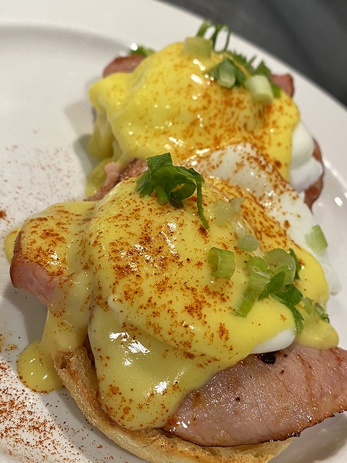 This Eggs Benedict isn't just breakfast&mdash;it's a sunrise masterpiece with hollandaise cascading like a buttery waterfall over perfectly poached eggs and Canadian bacon.