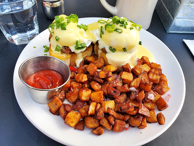 Eggs Benedict so perfectly executed it could make a French chef weep with joy, paired with home fries that redefine potato perfection.