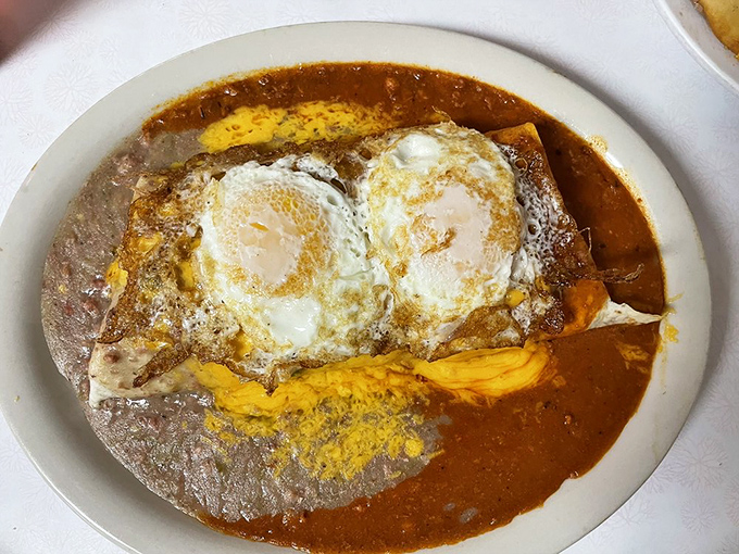Huevos rancheros that could make a rooster crow with pride. Those sunny-side-up eggs floating on a sea of red chile sauce are pure breakfast poetry.