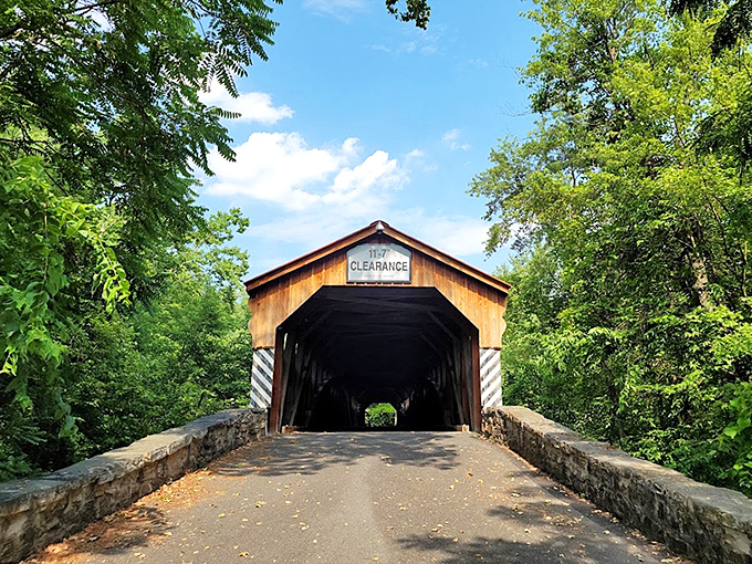 "Clearance" signs: the original low-bridge warning system. This wooden sentinel has been greeting travelers since Theodore Roosevelt was in office.