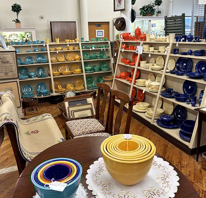 A rainbow of vintage Fiestaware stands at attention, each vibrant piece whispering of Sunday dinners and holiday gatherings long past.