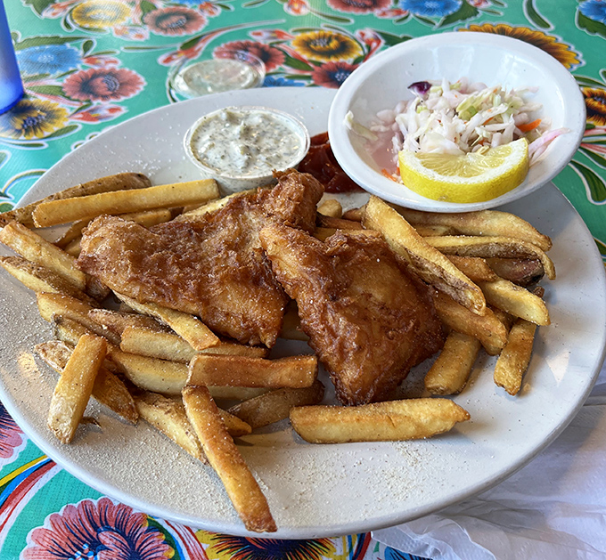 Golden-battered fish nestled among hand-cut fries with house-made tartar sauce. This isn't just food; it's edible coastal poetry on a plate.