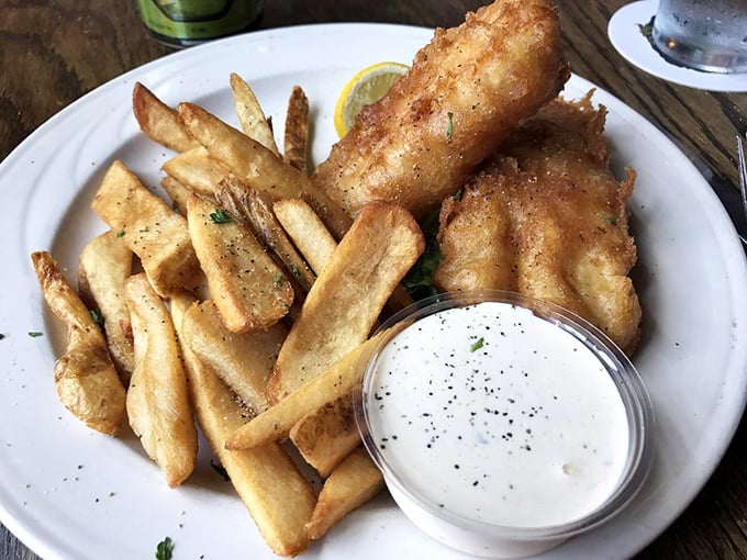 Golden-brown perfection arrives with that satisfying crackle that announces you've found the real deal – proper fish and chips at last.