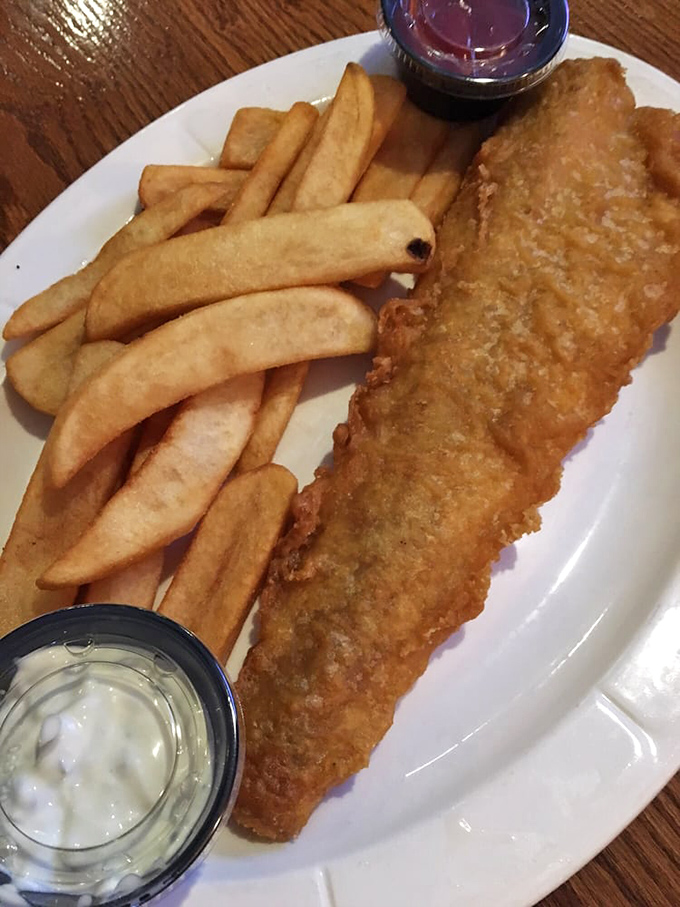 Golden-battered fish that shatters with each bite, paired with chips that could make a potato farmer weep with pride.