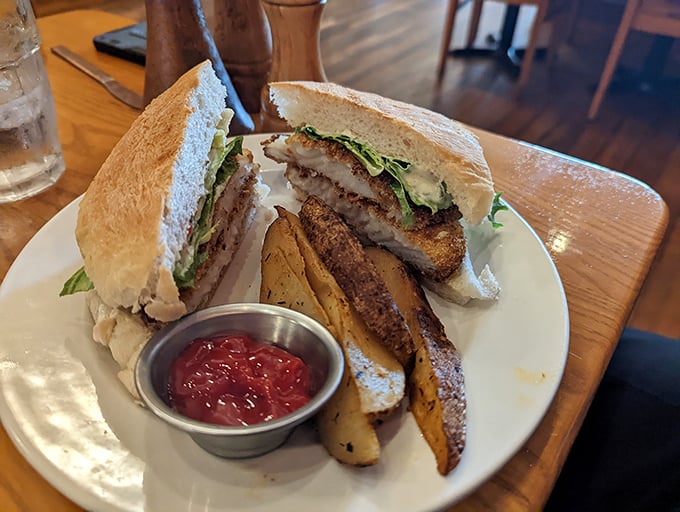 Behold the legendary fish sandwich in its full glory—crispy exterior, flaky interior, and those perfectly seasoned potato wedges that'll make you forget French fries exist.