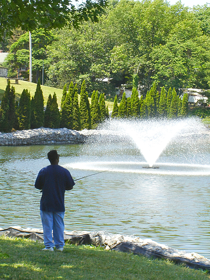 A peaceful moment at the park pond where a fisherman demonstrates the art of doing absolutely nothing productive&mdash;and looking completely fulfilled while doing it.
