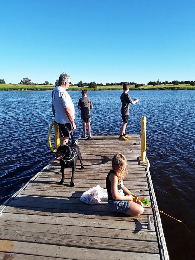 Family fishing from a sun-drenched dock&mdash;where catching memories often proves more valuable than catching fish.