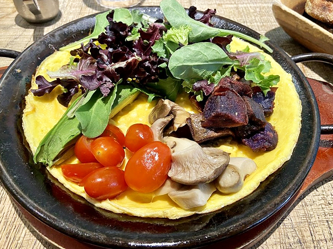 This flat omelet isn't just breakfast&mdash;it's edible sunshine adorned with garden-fresh toppings that make vegetables feel like they're attending a formal party.