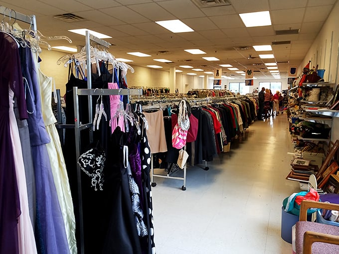 Formal dresses hang like colorful promises of special occasions, each with a story from its first life waiting to be continued.