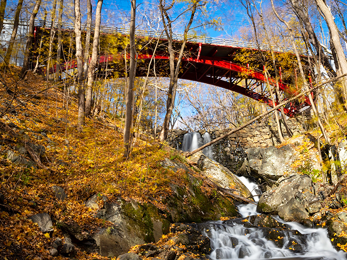 Nature and engineering in perfect harmony&mdash;this red bridge spans Foundry Brook like an exclamation point against autumn's golden paragraph.