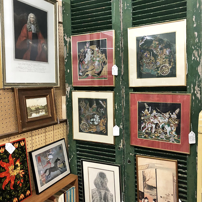 Art that spans centuries, displayed on weathered green shutters. From formal portraits to whimsical illustrations, someone's discarded decor becomes your conversation piece.