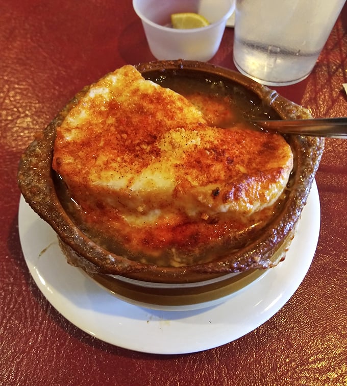 Behold, the French onion soup in all its glory! That golden, bubbling cheese cap is nature's perfect seal over a broth that's been simmering toward perfection.