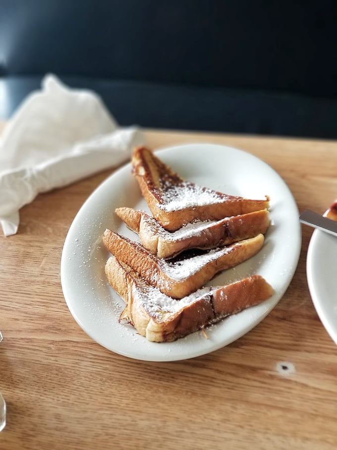 Golden-brown perfection dusted with powdered sugar. This French toast doesn't need a passport to transport you to breakfast heaven.