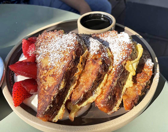 The French toast that launched a thousand return visits. Golden, custard-soaked brioche with fresh berries that makes you wonder if you've been doing breakfast wrong your entire life.