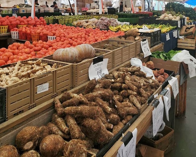 Nature's bounty displayed market-style. These aren't your supermarket vegetables; they're conversation starters with dirt still telling tales of local soil.