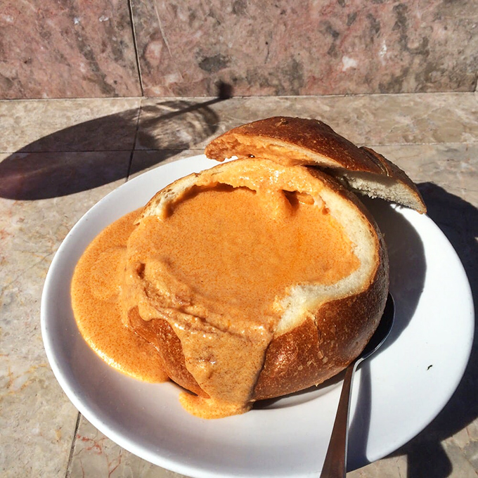 This lobster bisque isn't just soup; it's a warm, creamy hug in a sourdough bowl that might make you weep with joy.
