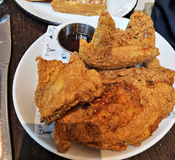 Golden-brown perfection on a plate. This fried chicken's crackling exterior guards juicy meat beneath&mdash;a crispy armor protecting delicious treasure.