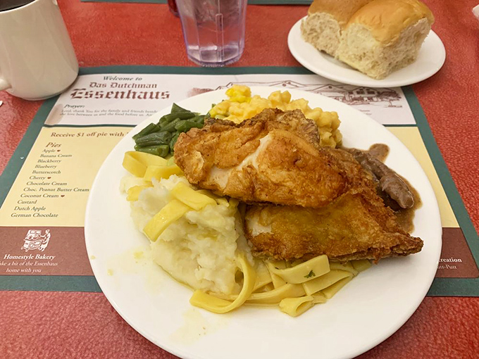 Fried chicken resting on a bed of homemade noodles – a plate that whispers "nap time" even as you're reaching for another bite.