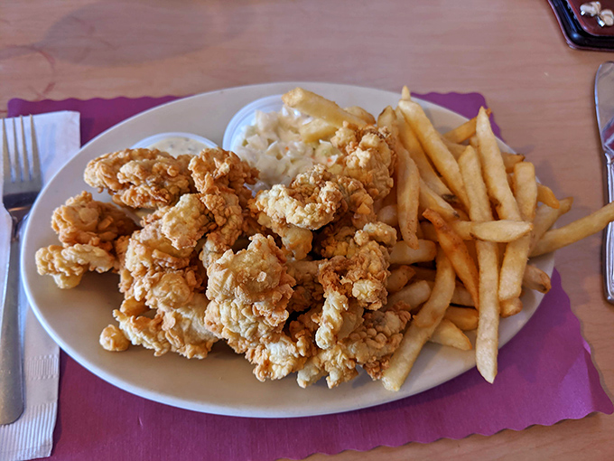 Golden-battered fried clams that snap with freshness, served with crispy fries and a dollop of tartar sauce&mdash;Maine's perfect coastal trio.