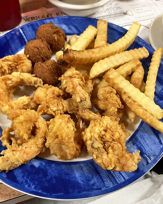 Golden-battered shrimp that snap between your teeth, paired with crispy fries and hush puppies&mdash;a holy trinity of Southern comfort.