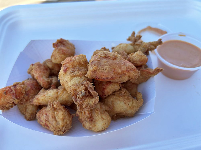 Golden-fried lobster bites that make you question why you've wasted years eating anything else. That dipping sauce? Just the cherry on top of seafood perfection.