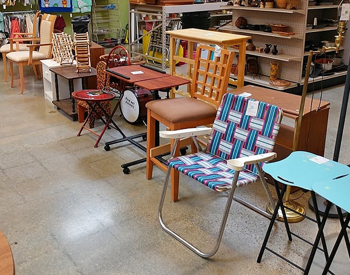 Furniture that tells stories waits for its next chapter. That lawn chair might have witnessed countless backyard barbecues before landing here.