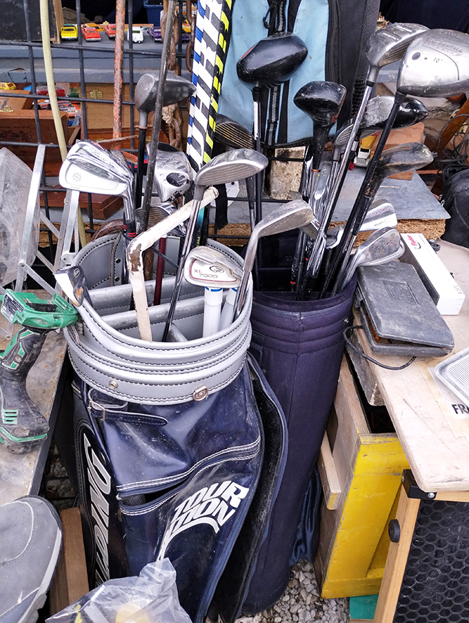 Golf clubs standing at attention like soldiers, waiting to improve someone's weekend game without destroying their wallet.