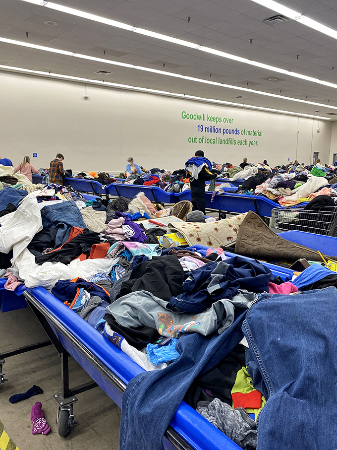 Row after row of clothing bins create a textile treasure hunt where patience rewards the persistent with wardrobe gems.