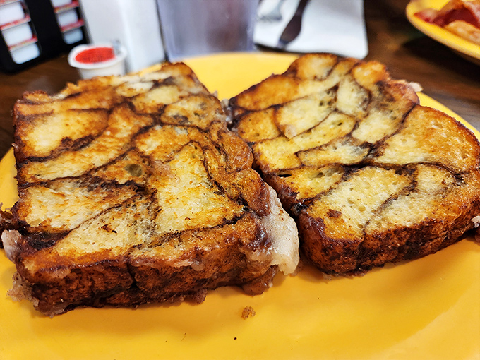 Behold the star of the show: grilled cinnamon bread that makes French toast look like it needs a promotion.