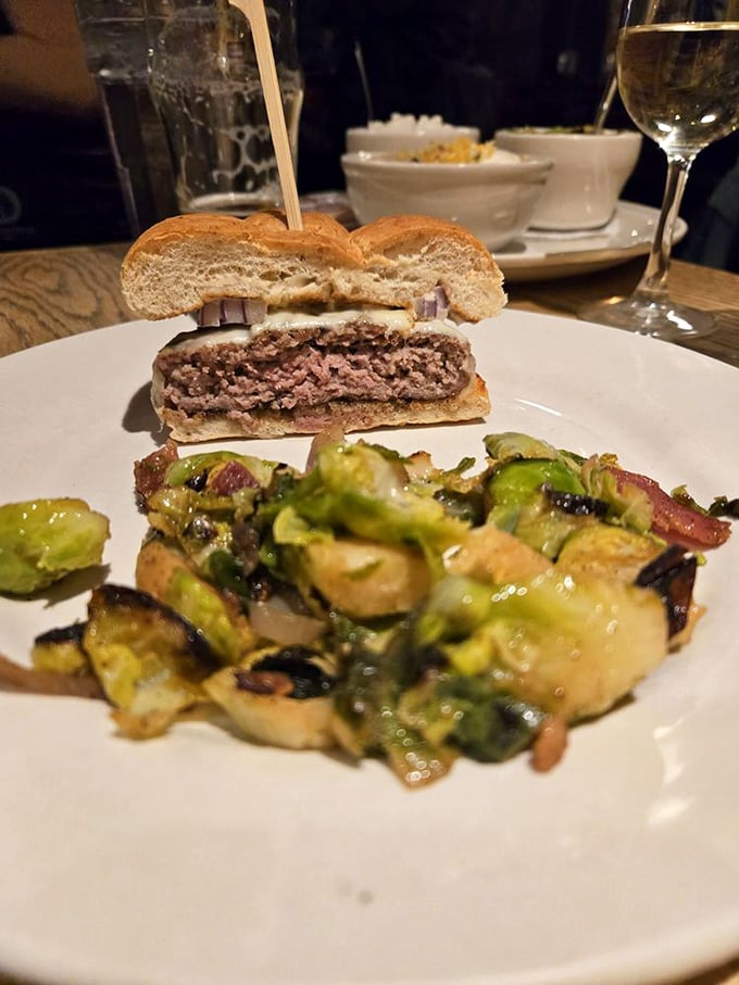 The legendary lamb burger in all its glory &ndash; perfectly pink inside with a side of Brussels sprouts that might convert even the most dedicated vegetable skeptic.