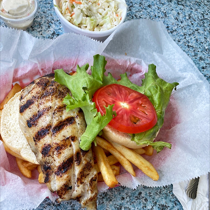 The grilled grouper sandwich&mdash;Florida's answer to the question "What does paradise taste like?" Char marks are nature's autograph on perfectly cooked fish.
