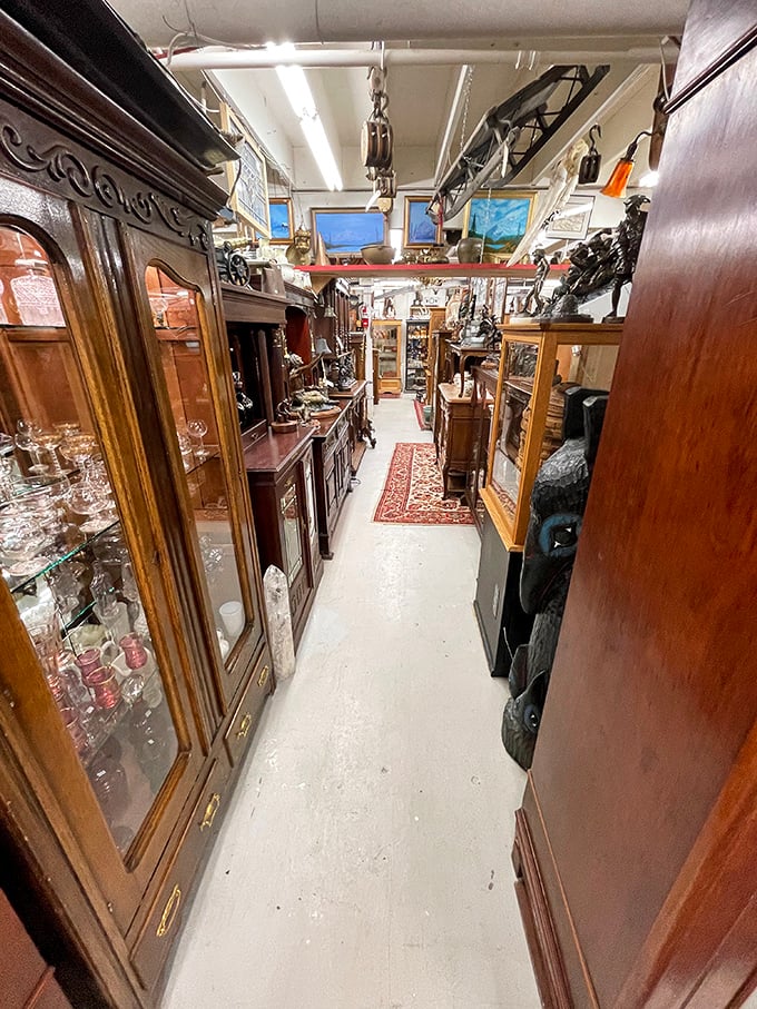 Narrow pathways flanked by gleaming wood cabinets create a treasure maze where getting lost is half the fun.