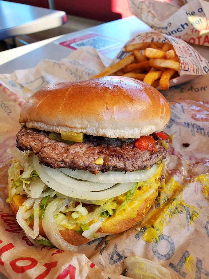 Behold the masterpiece &ndash; layers of fresh veggies, perfectly seasoned beef, and that signature green chile peeking out like a spicy surprise.