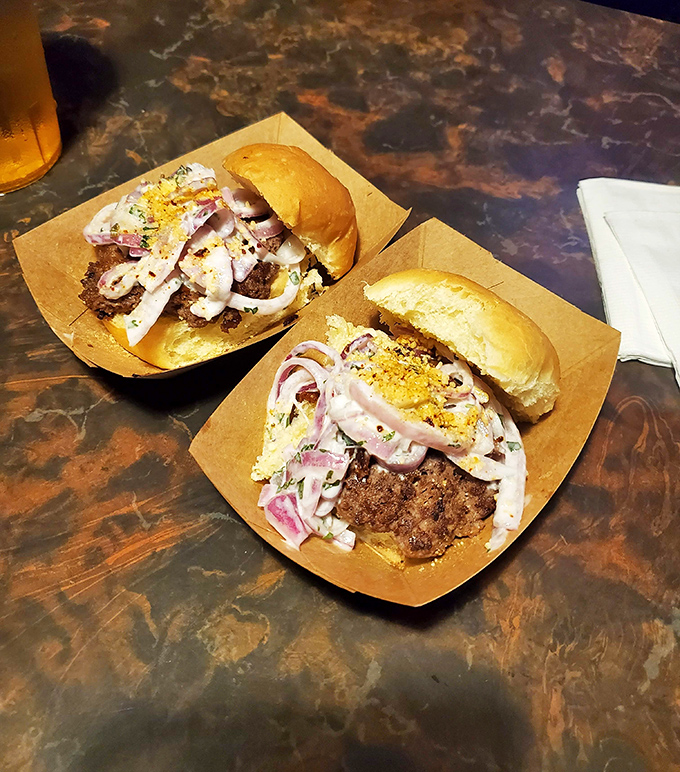 These aren't just sliders &ndash; they're edible works of art topped with enough onions to make your taste buds weep with joy.