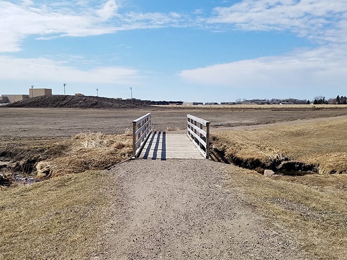 A simple wooden bridge stretches across an undeveloped area&mdash;the perfect metaphor for Harrisburg's transition from farming community to thriving suburb, connecting past to future.