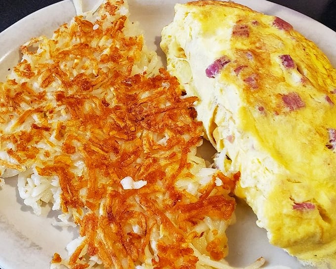 Behold, the hashbrowns that launched a thousand food dreams. Crispy exterior, tender interior&mdash;this is potato perfection sharing a plate with an omelet that means business.
