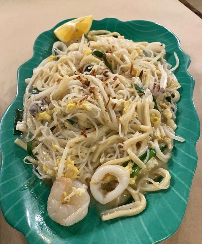 Hokkien Mee in all its glory&mdash;silky noodles, plump seafood, and that essential squeeze of lime. One bite and suddenly your dining companions become background noise to this plate of perfection.