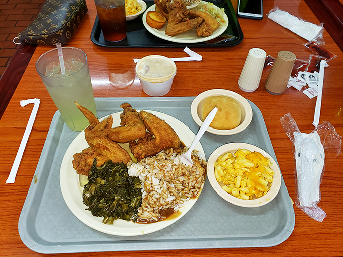 A tray of golden fried chicken, collard greens, and mac & cheese—the holy trinity of soul food. That sweet tea is practically mandatory in Georgia.