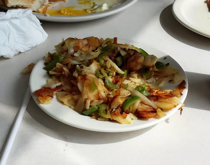 These home fries aren't just cooked, they're negotiated with the griddle to achieve perfect crispiness. Green peppers add pops of color to this potato masterpiece.