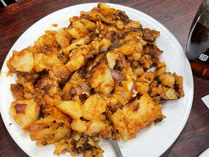 These aren't just home fries; they're potato perfection—crispy, seasoned edges giving way to pillowy centers that make ordinary breakfast potatoes seem like distant, inferior relatives.