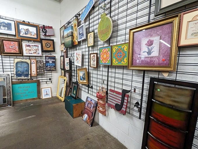 Art gallery or thrift store? The line blurs delightfully as framed inspirational quotes mingle with landscapes and abstract pieces. One person's discard becomes another's masterpiece.