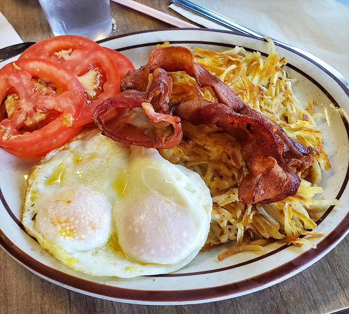 Breakfast perfection doesn't need fancy words&mdash;just perfectly runny eggs, crispy hash browns, and bacon that would make even a vegetarian pause.